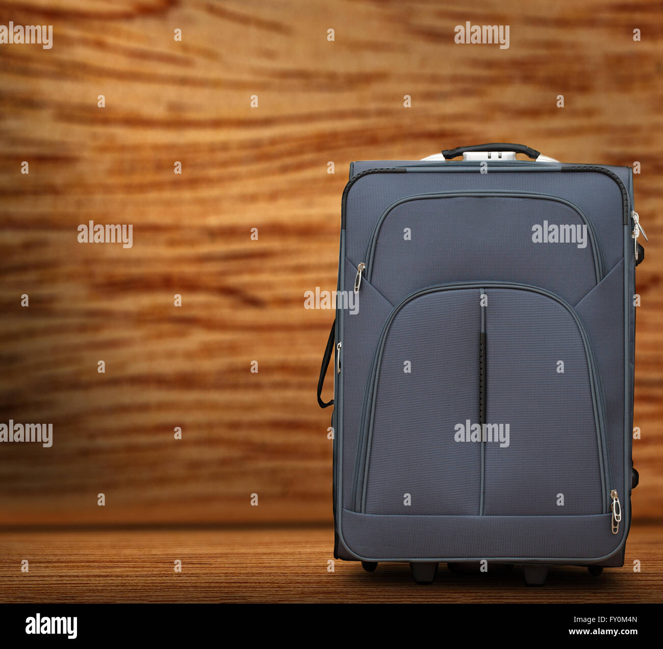 Large gray suitcase on wheels in closeup Stock Photo - Alamy