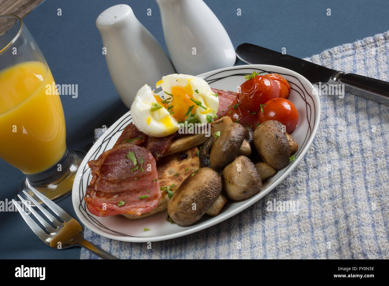 An English style breakfast of Welsh Cake, Bacon, Mushrooms, Tomatoes ...