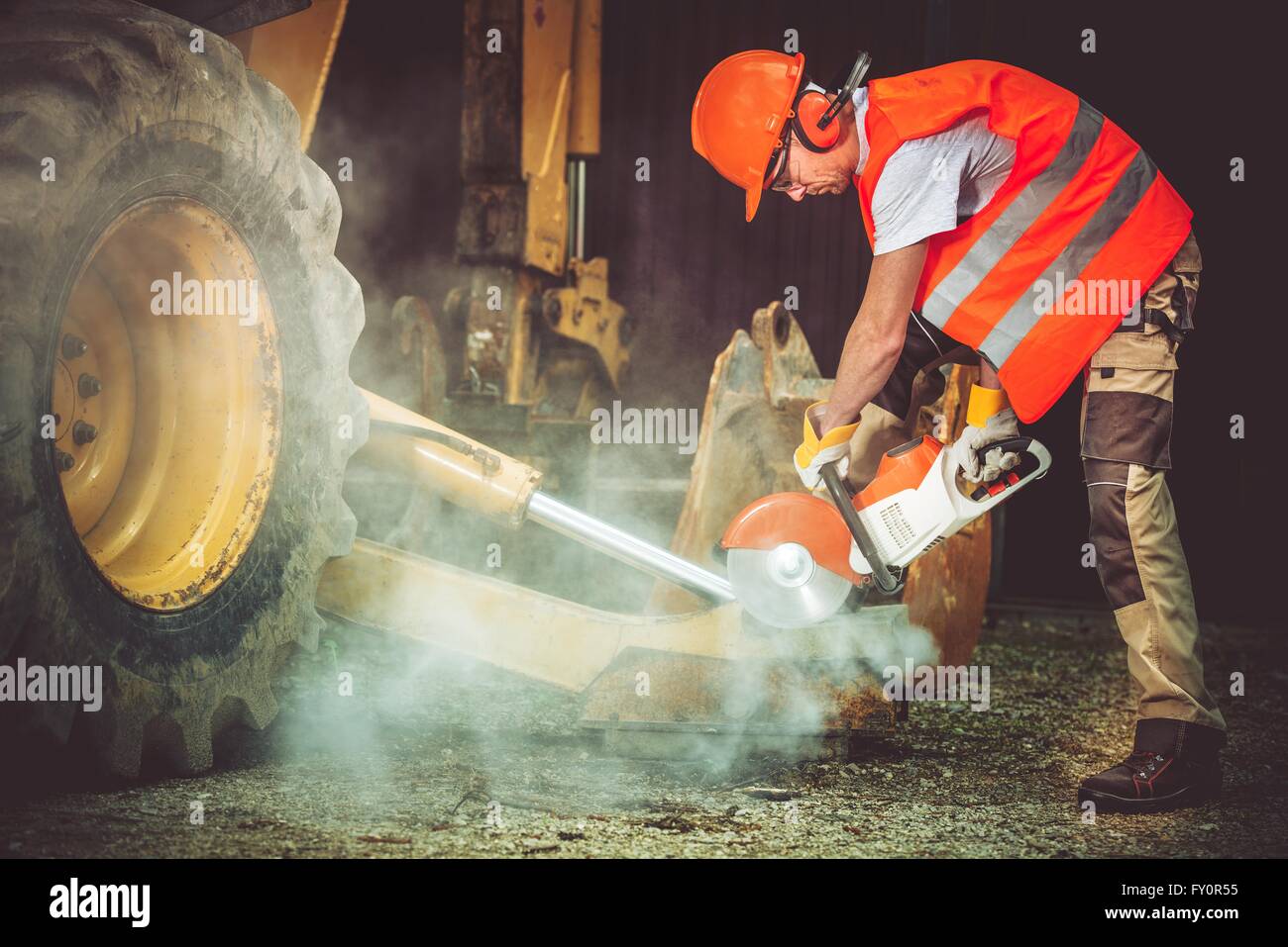Construction Worker in Action. Worker Cutting Concrete by Using Heavy ...