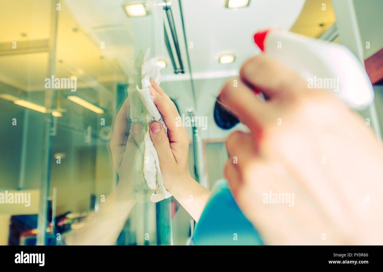 Office Windows Cleaning. Male Worker Cleaning Glass Walls in the Office ...