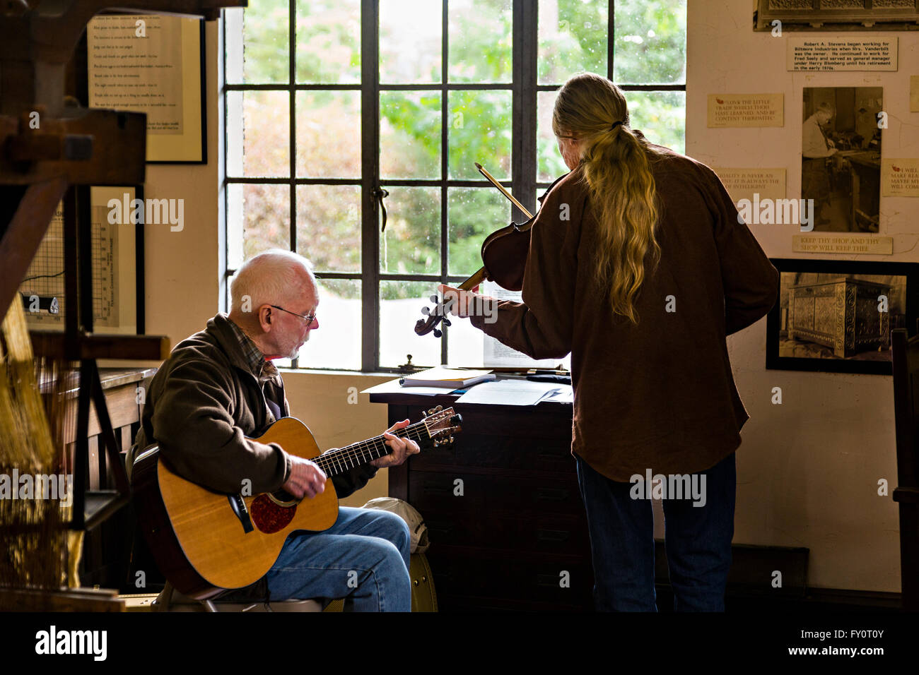 Bluegrass musicians practice playing inside the North Carolina Homespun ...