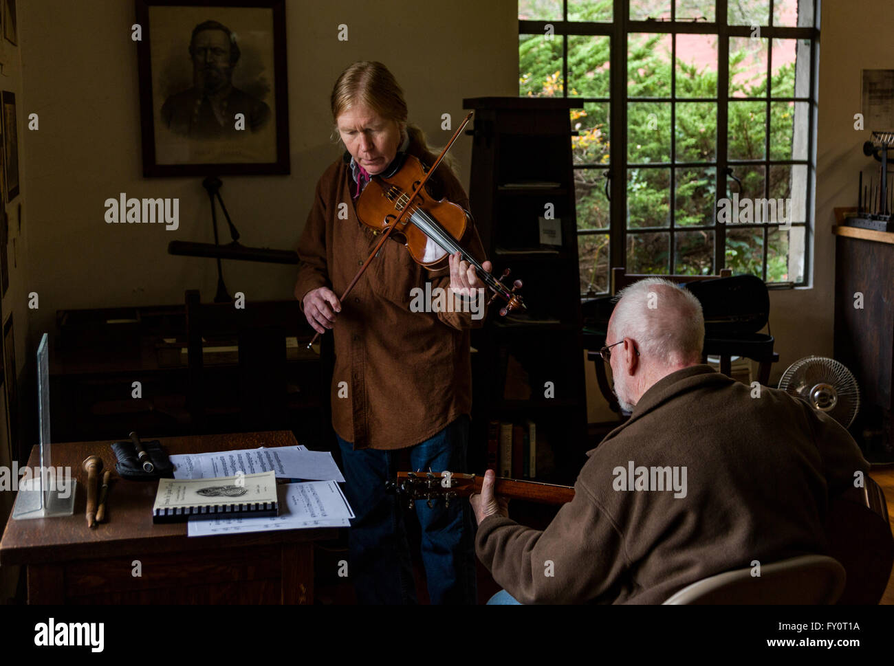Bluegrass musicians practice playing inside the North Carolina Homespun ...