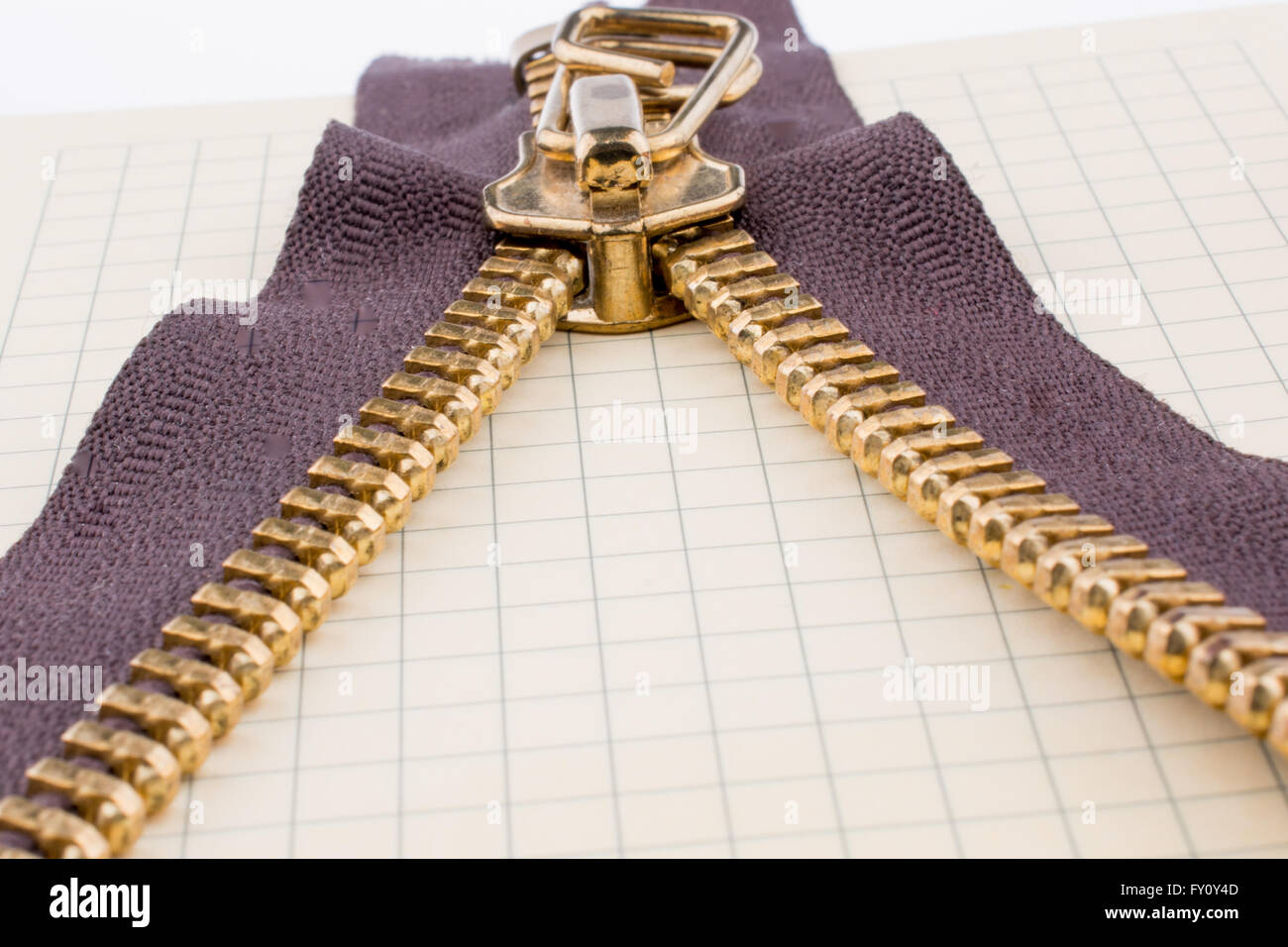 Spiral notebook through a zipper on a white background Stock Photo - Alamy