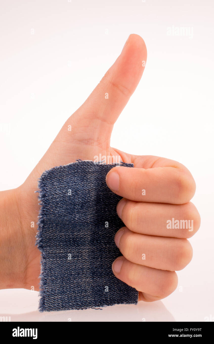 Hand holding a denim fabric piece on white background Stock Photo - Alamy