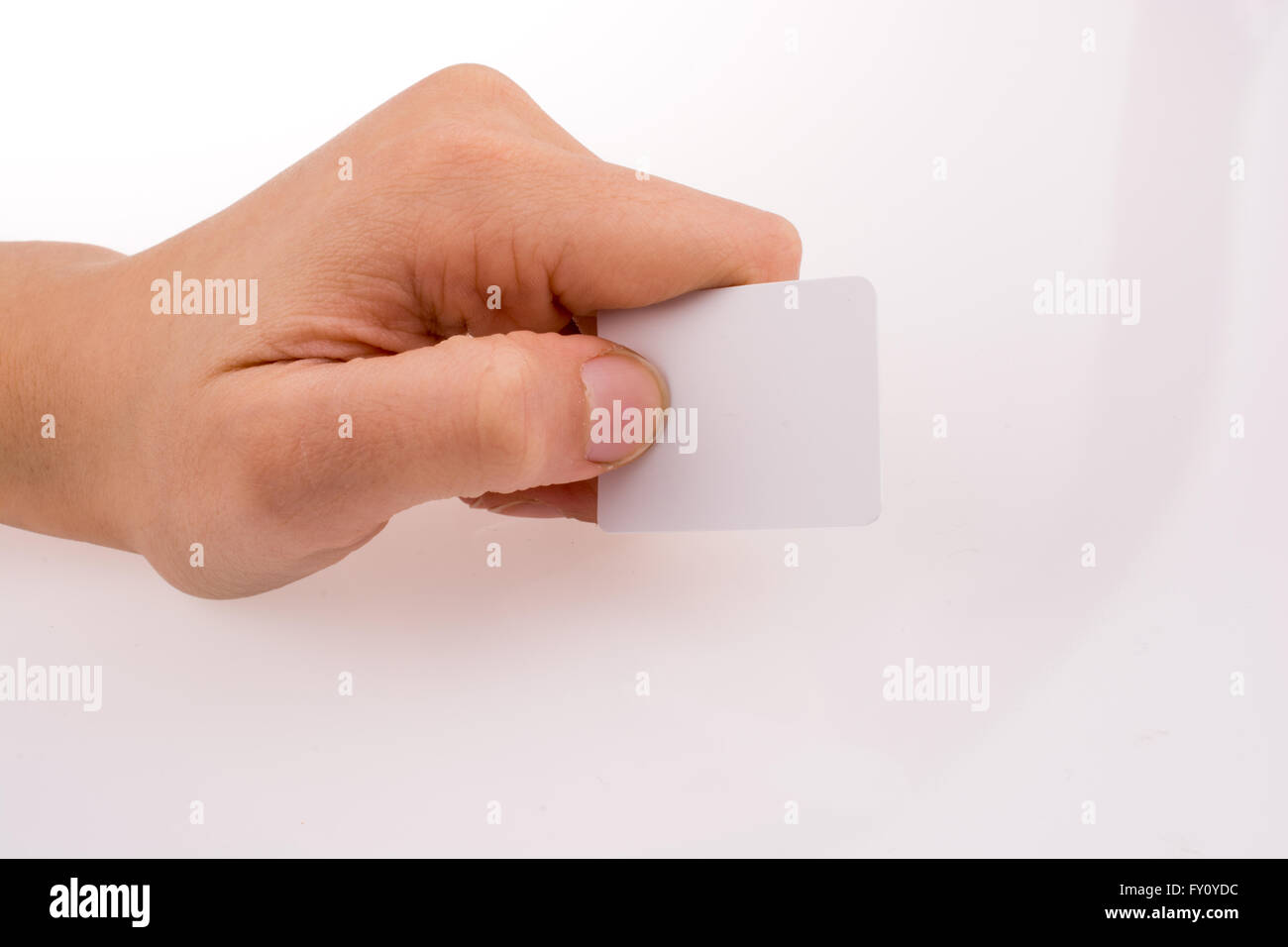 Hand holding a piece of paper on a white background Stock Photo - Alamy