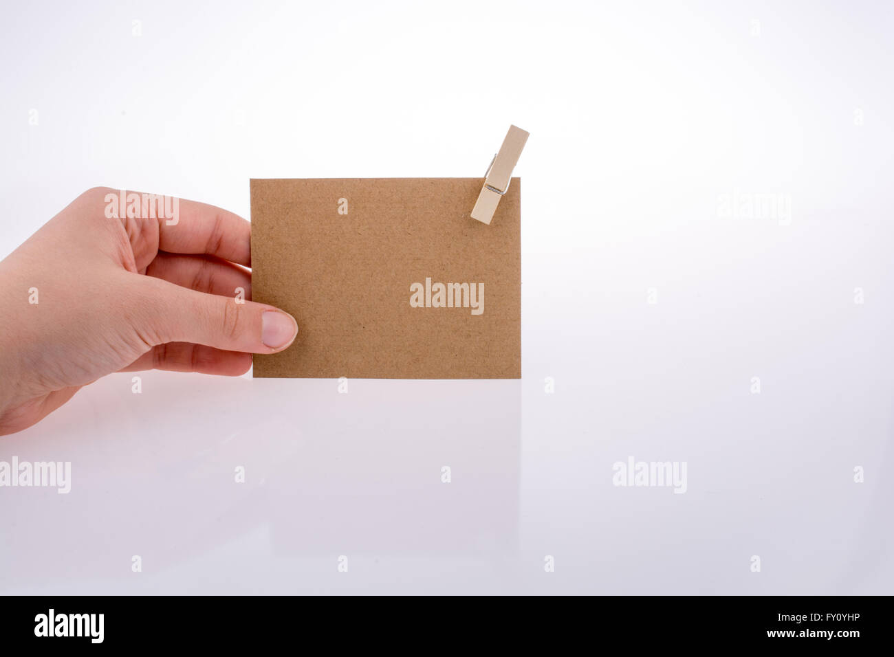 Hand holding a paper with a clip on it Stock Photo - Alamy