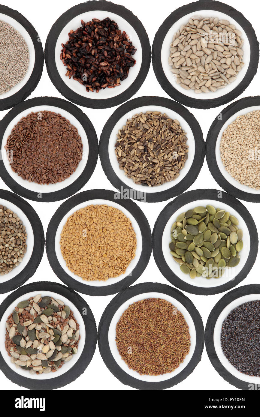 Seed food selection in porcelain bowls over slate rounds and white ...