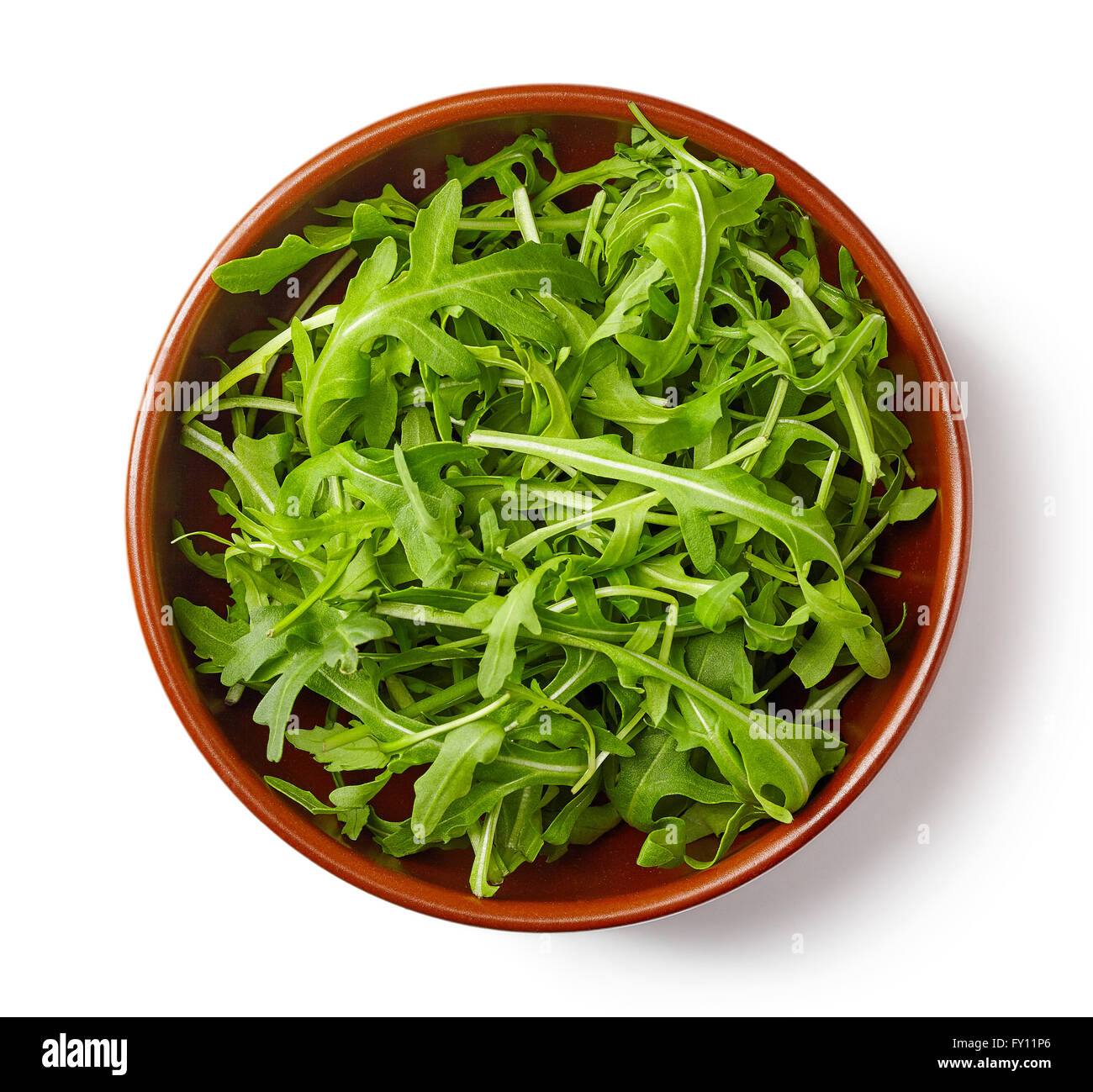 Fresh green arugula in bowl isolated on white background, top view ...
