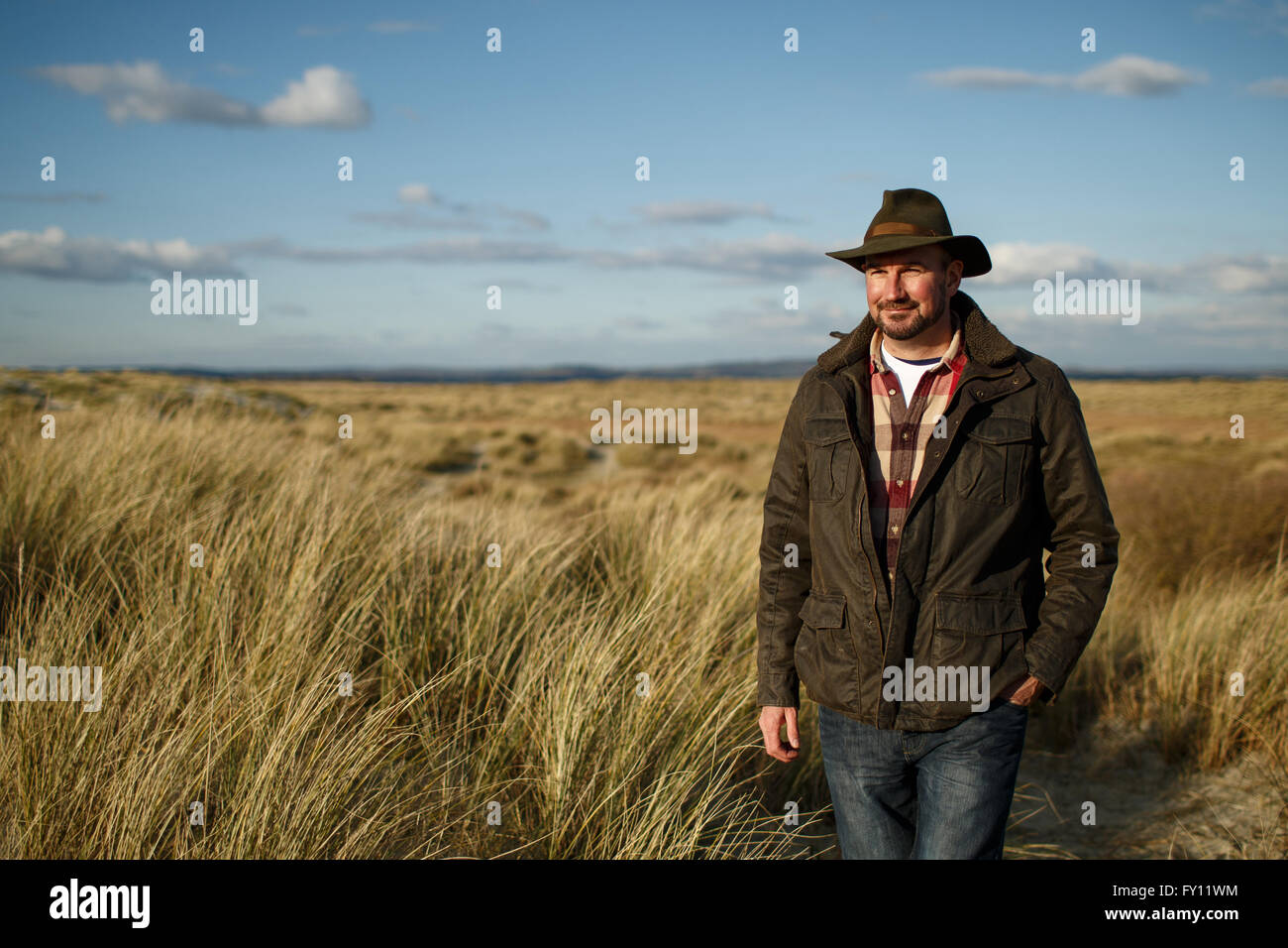 A man explores the coastline - Tristan Gooley Stock Photo - Alamy