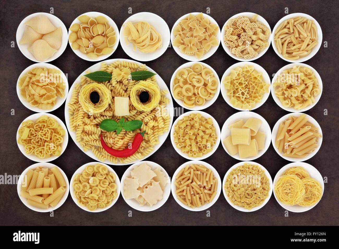 Abstract spaghetti and herb face with large pasta food selection in ...