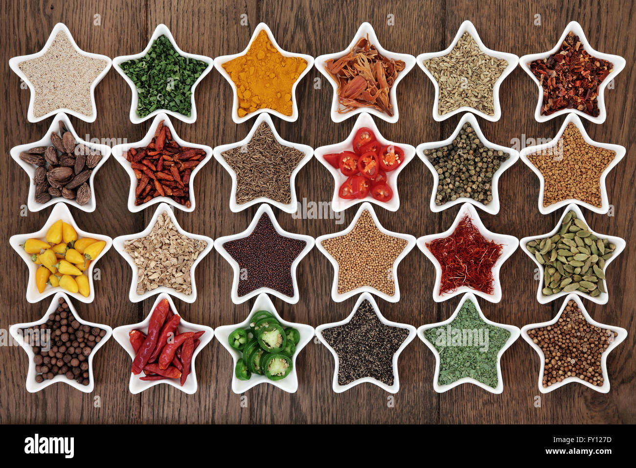 Large herb and spice selection in star shaped porcelain dishes over old ...