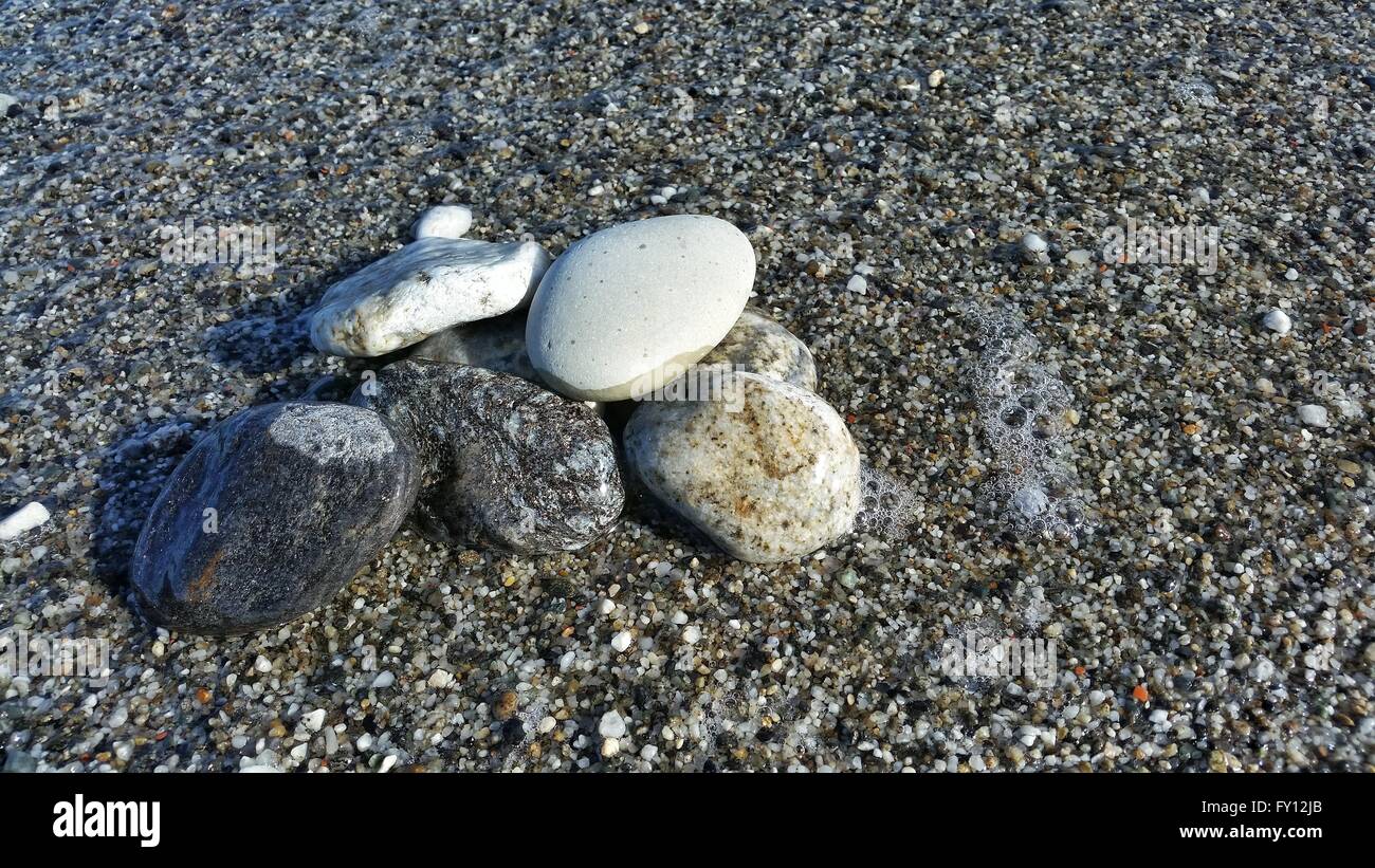 Some wet stones on the shoreline Stock Photo - Alamy