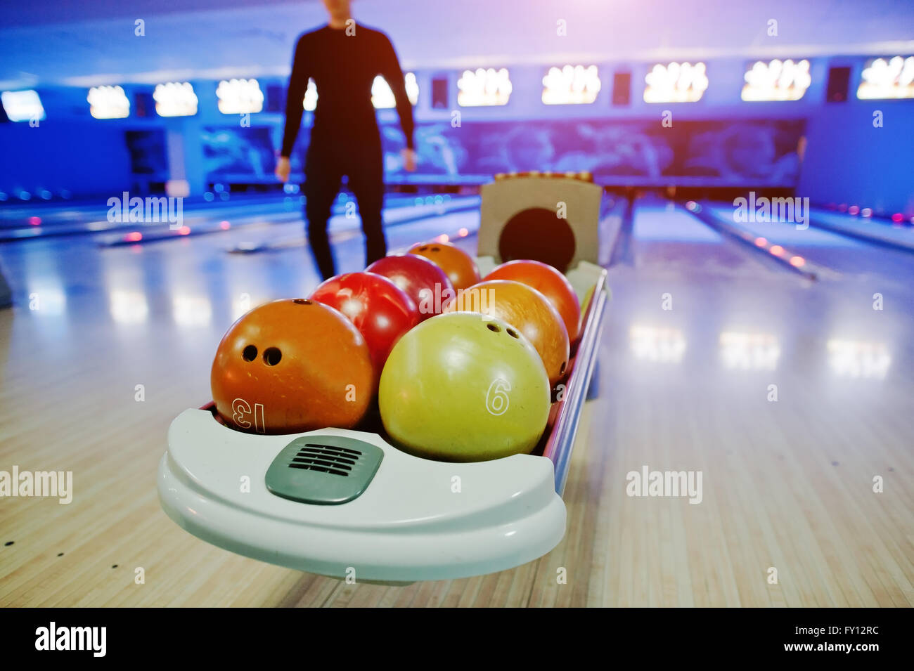 Bowling balls at bowl lift with ultraviolet lighting Stock Photo - Alamy