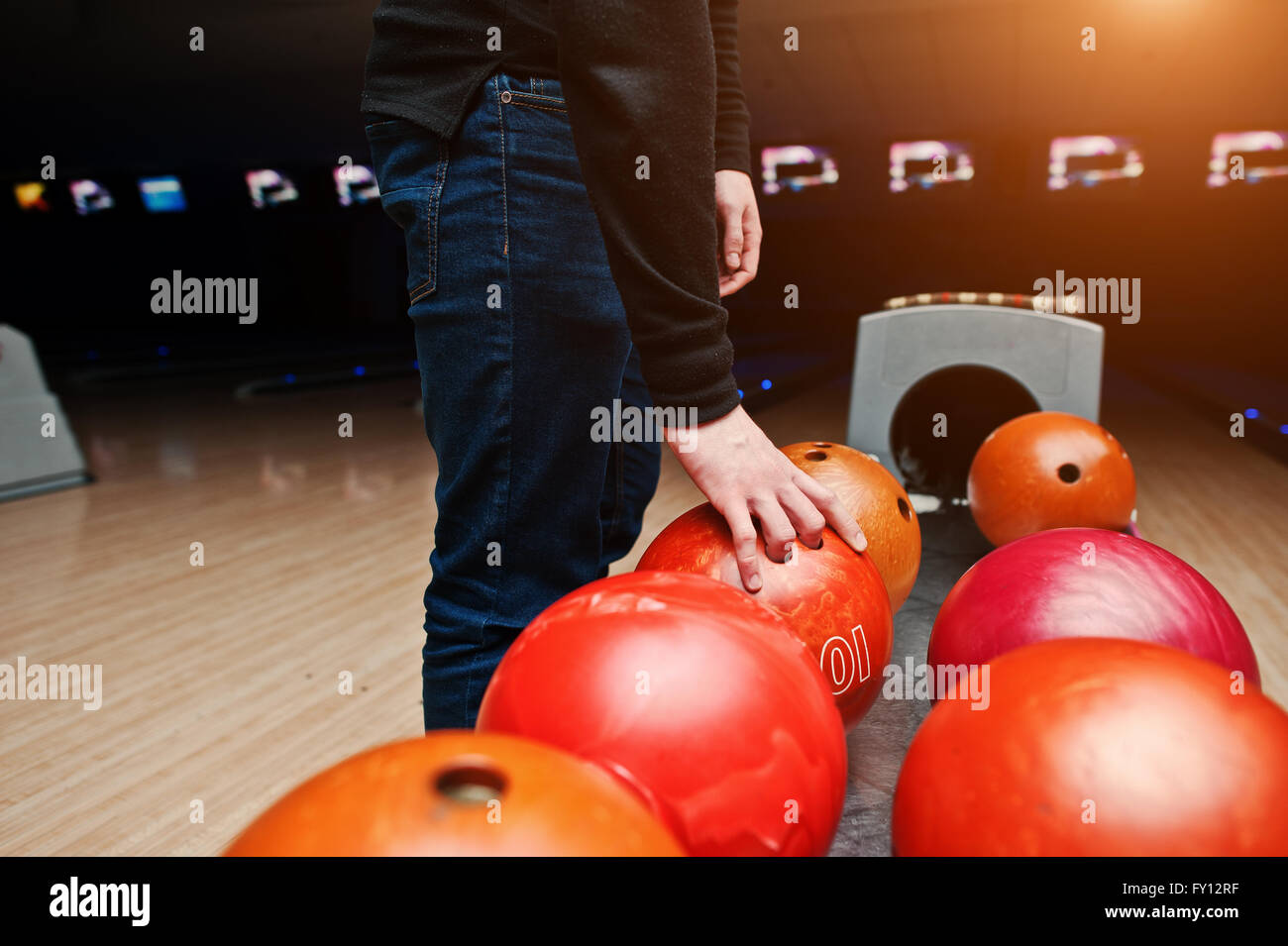 Close up of bowling player hand taking red ball from bowl lift Stock ...