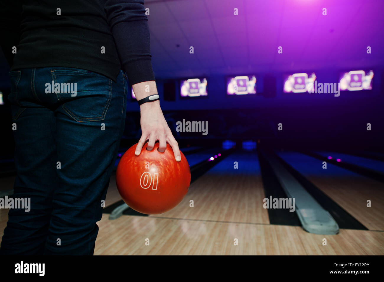 Hand of man player with bracelet holding bowling ball Stock Photo - Alamy