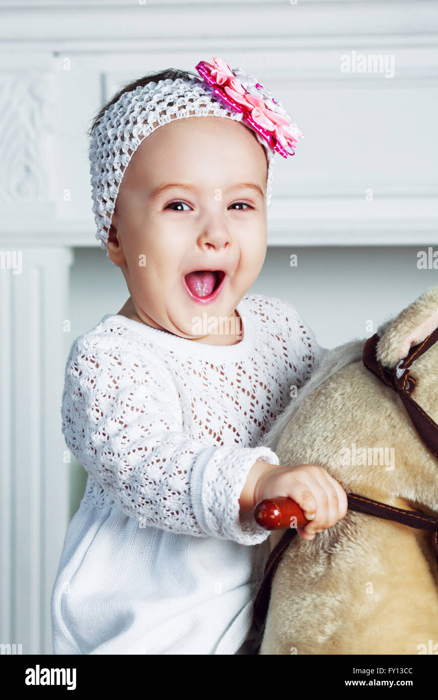 happy baby playing at home with a toy horse Stock Photo - Alamy