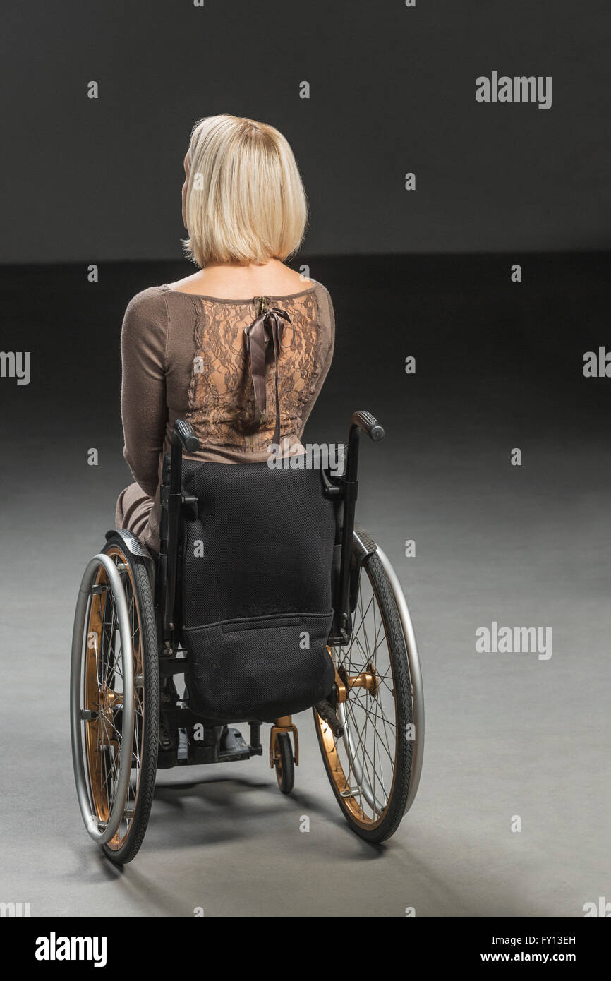 Rear view of disabled woman in wheelchair Stock Photo - Alamy