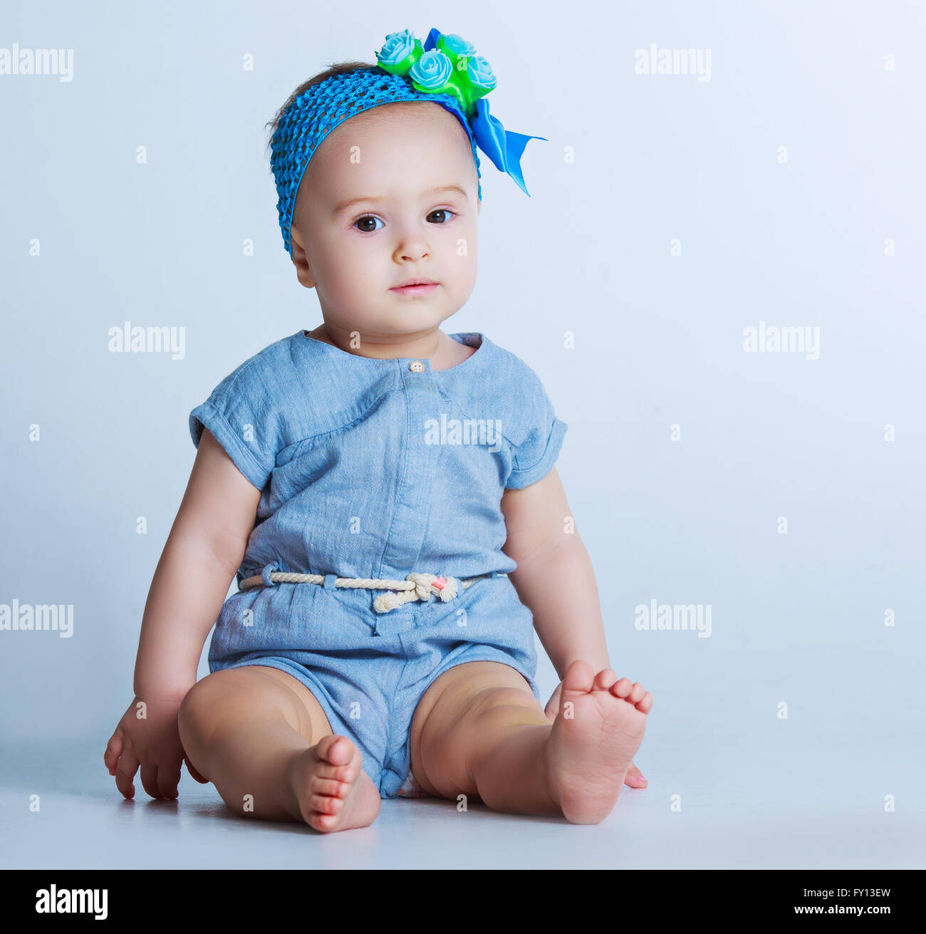 beautiful one year old baby against blue studio background Stock Photo ...