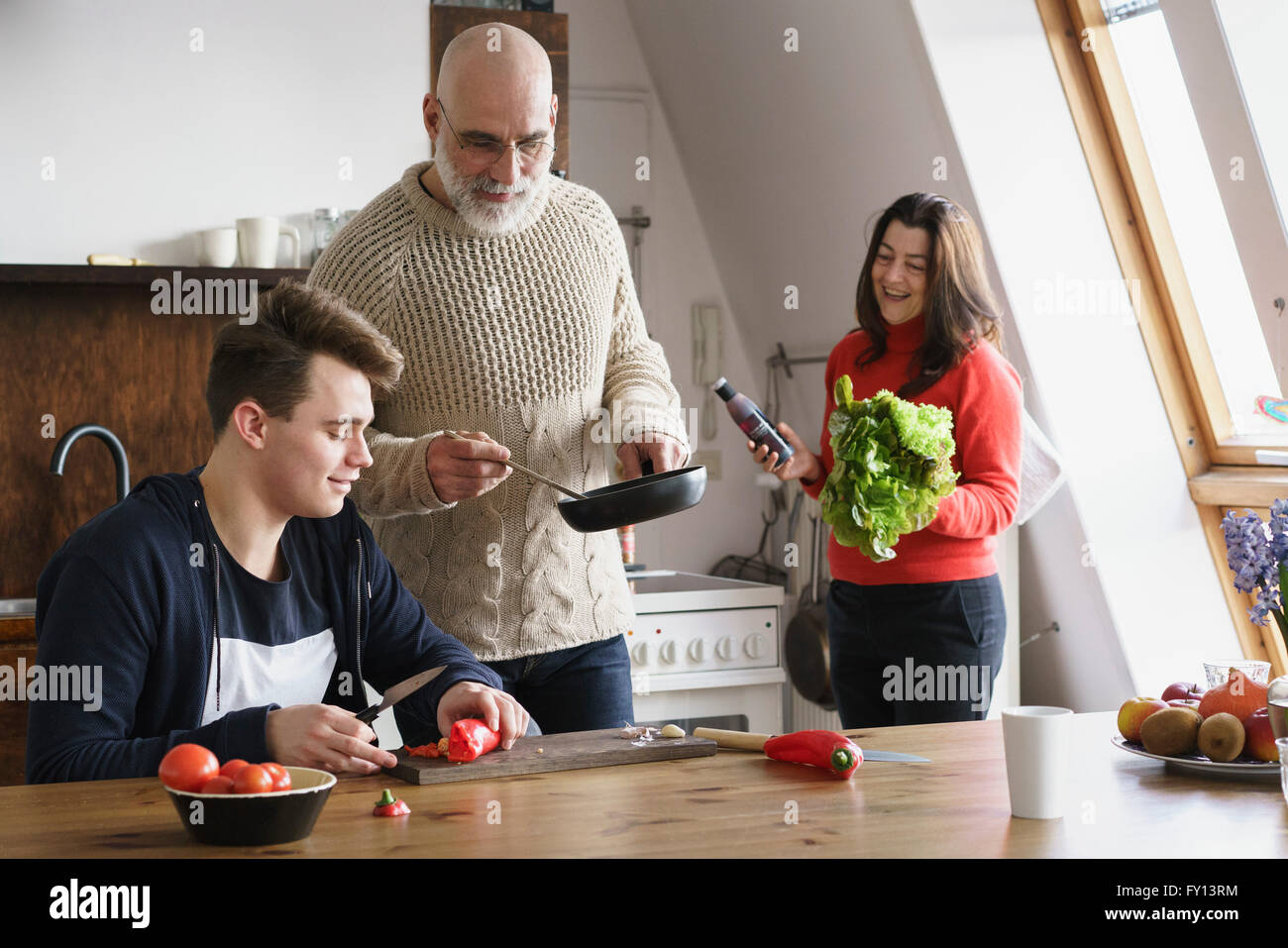 Happy family cooking food together at home Stock Photo - Alamy