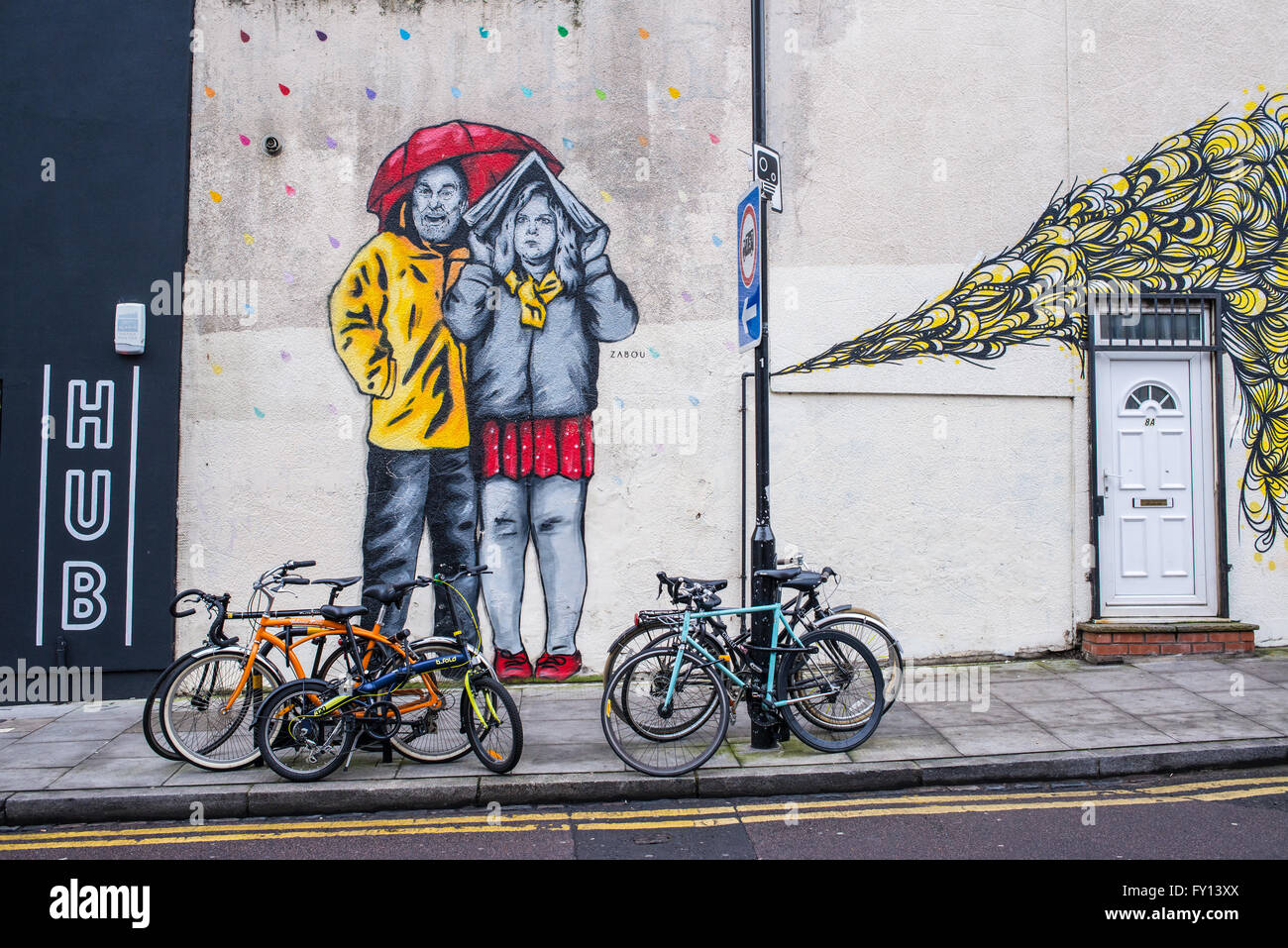 Big mural graffiti representing a surprised couple protecting from the ...