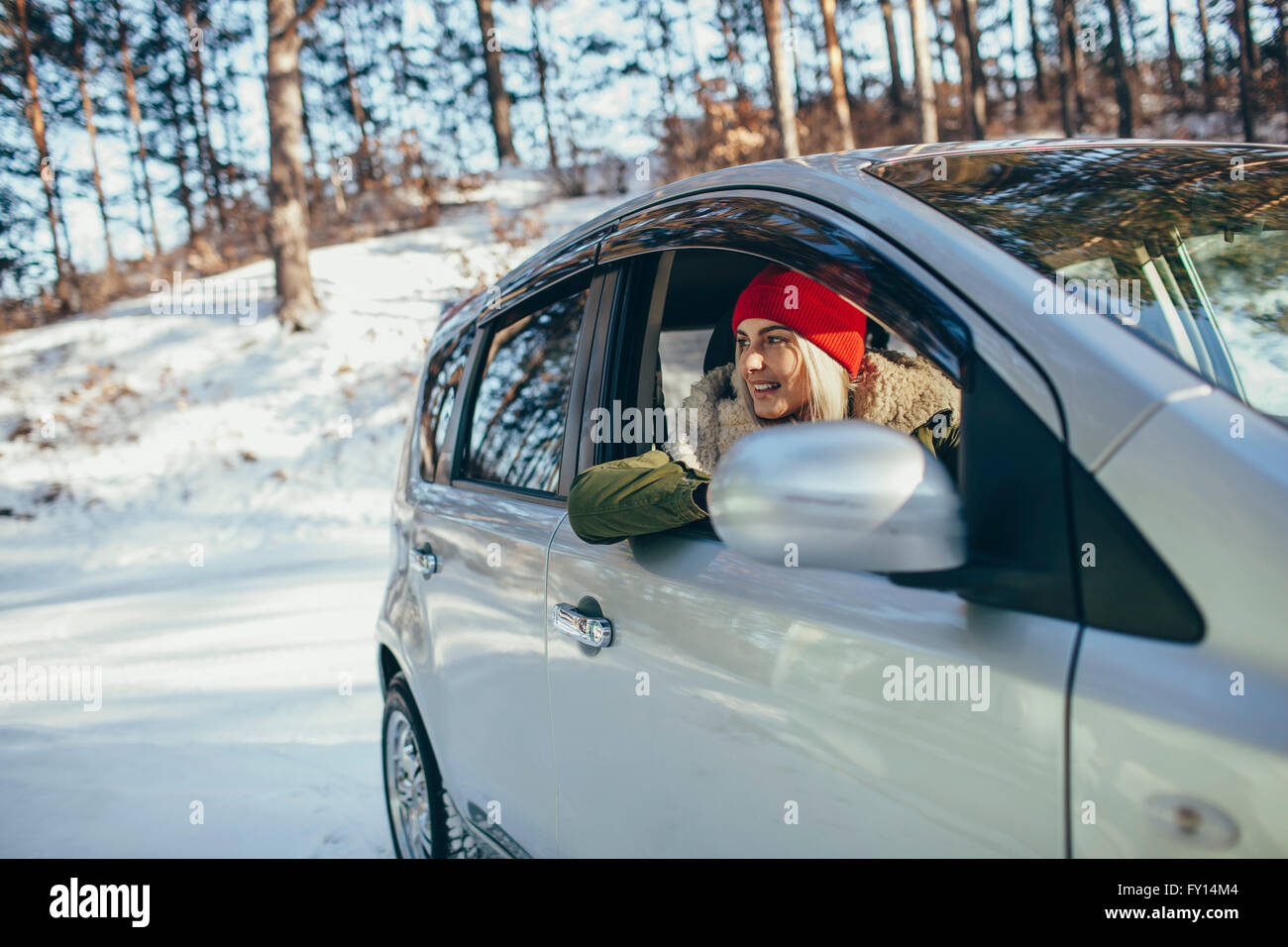 Happy young woman in car during winter Stock Photo - Alamy