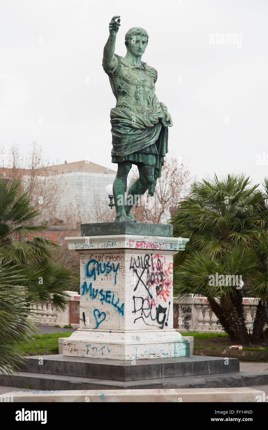 Low angle view of statue with graffiti at park Stock Photo - Alamy