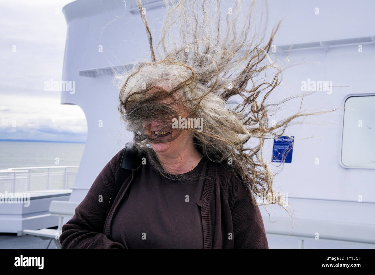 Wind bowing hair. Windy day on the ferry Stock Photo - Alamy