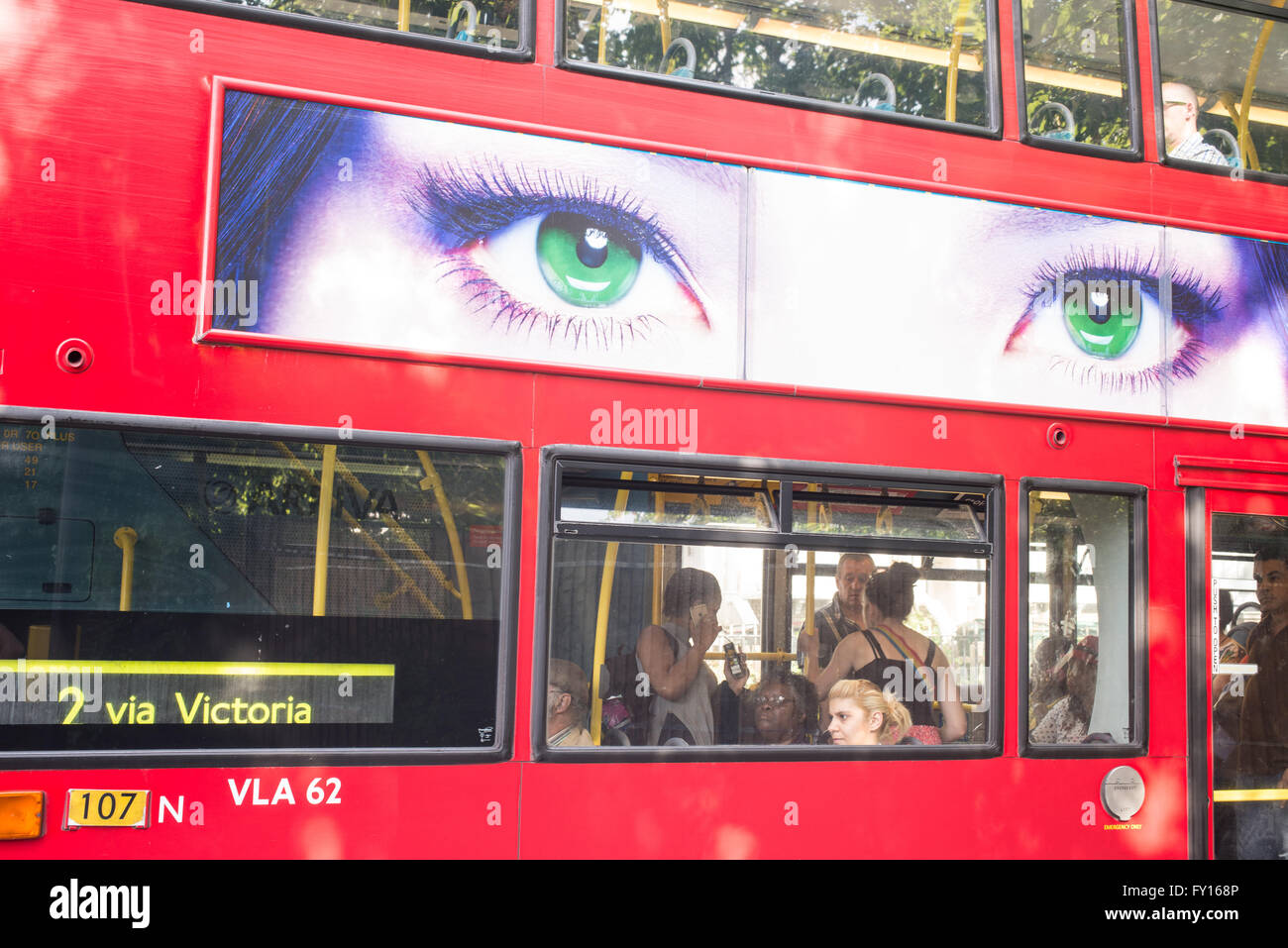 Advertising billboard on a red London bus with two big female green ...
