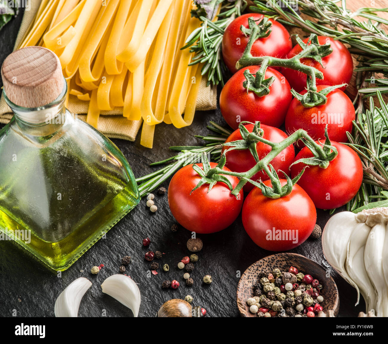 Pasta ingredients. Cherry-tomatoes, spaghetti pasta, rosemary and ...
