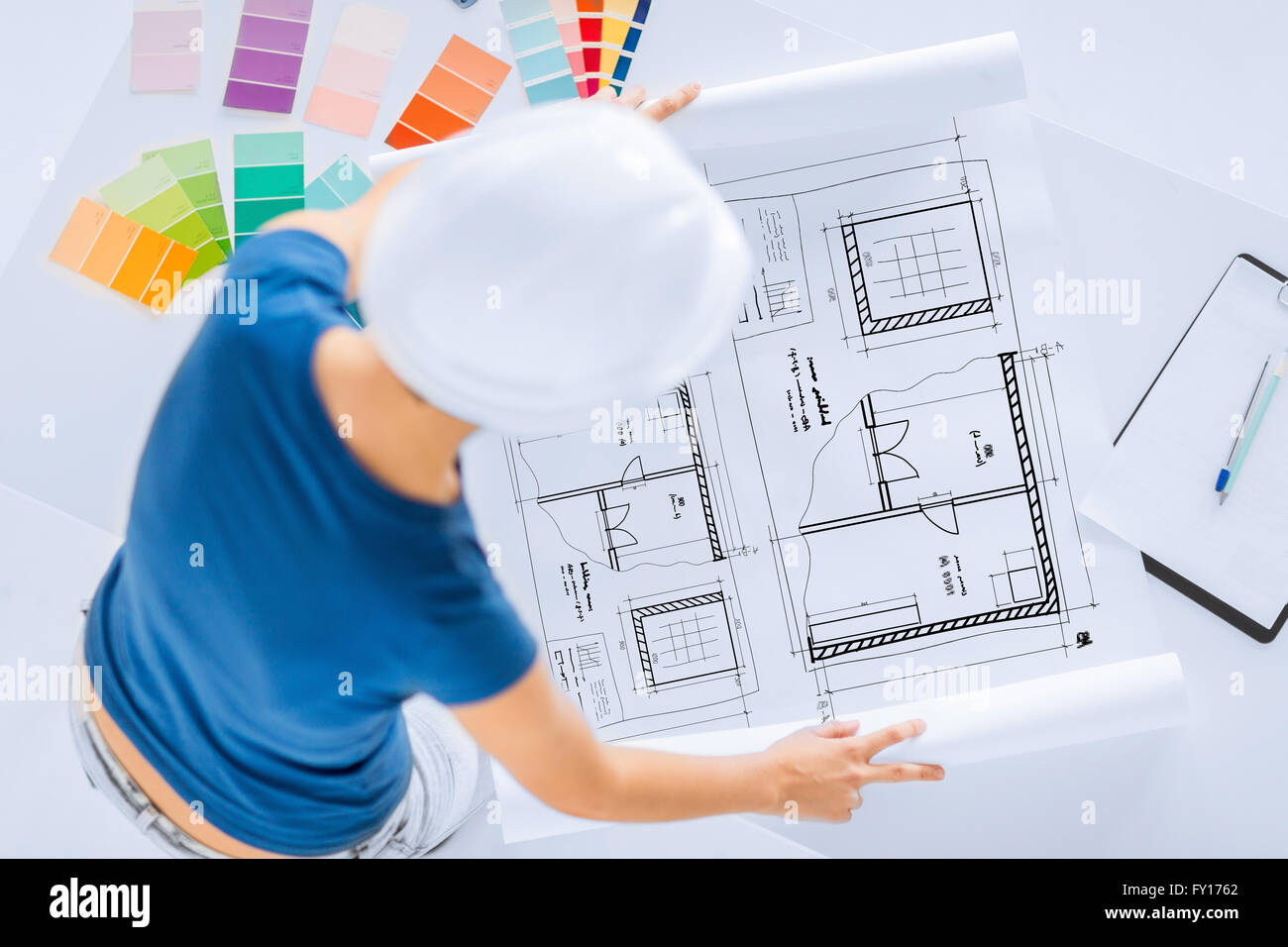 woman with color samples and blueprint Stock Photo - Alamy