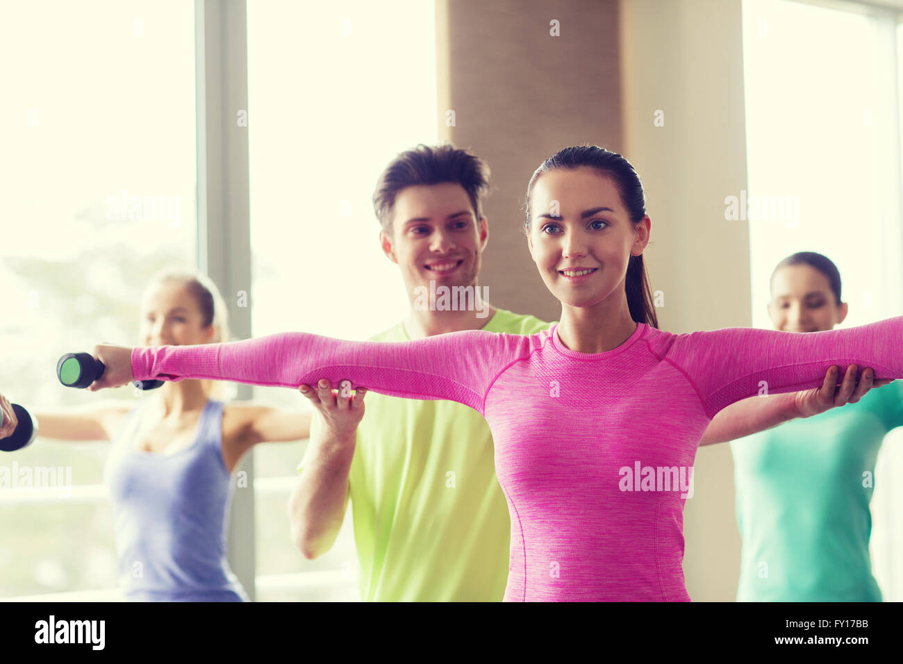 group of smiling people working out with dumbbells Stock Photo - Alamy