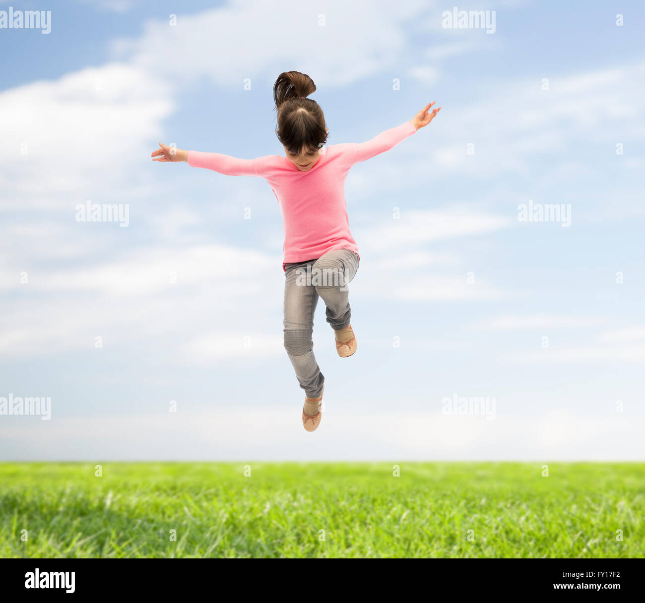 happy little girl jumping in air Stock Photo - Alamy