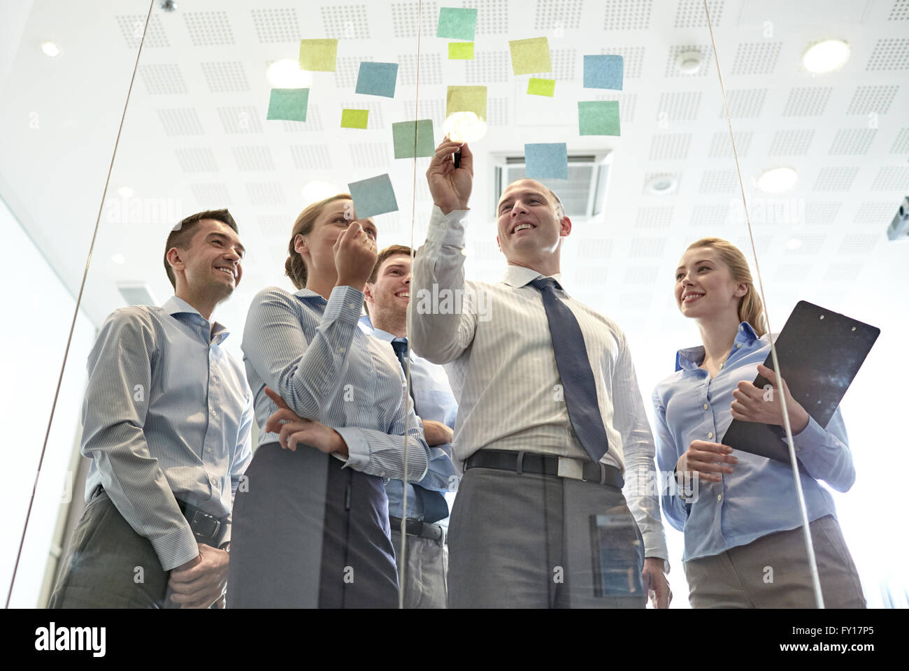 smiling business people with marker and stickers Stock Photo - Alamy