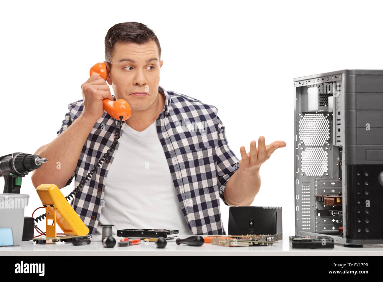 Confused PC technician talking on the phone isolated on white ...