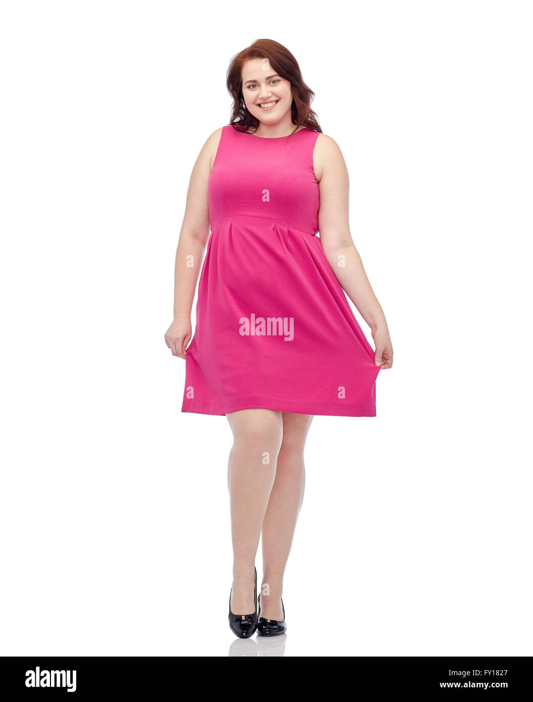 happy young plus size woman posing in pink dress Stock Photo - Alamy
