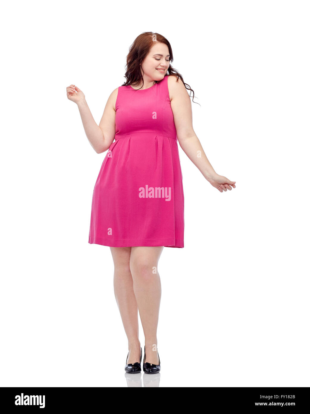 happy young plus size woman dancing in pink dress Stock Photo - Alamy