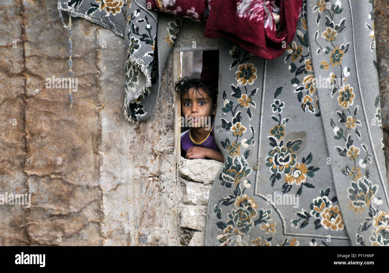 Sanaa, Yemen. 20th Apr, 2016. A girl from a poor family looks out ...