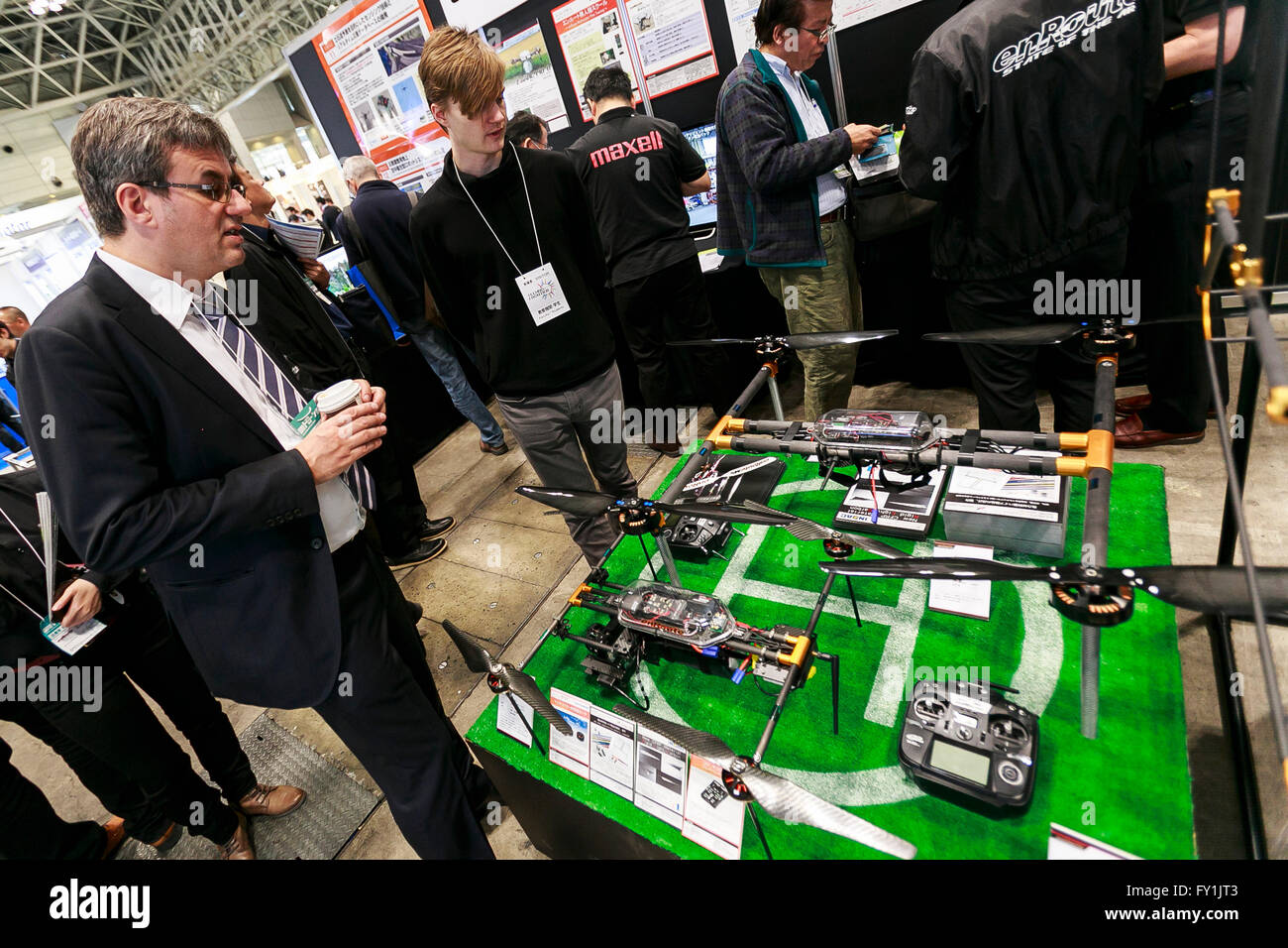Visitors look at a drone on display at the Techno-Frontier 2016 ...