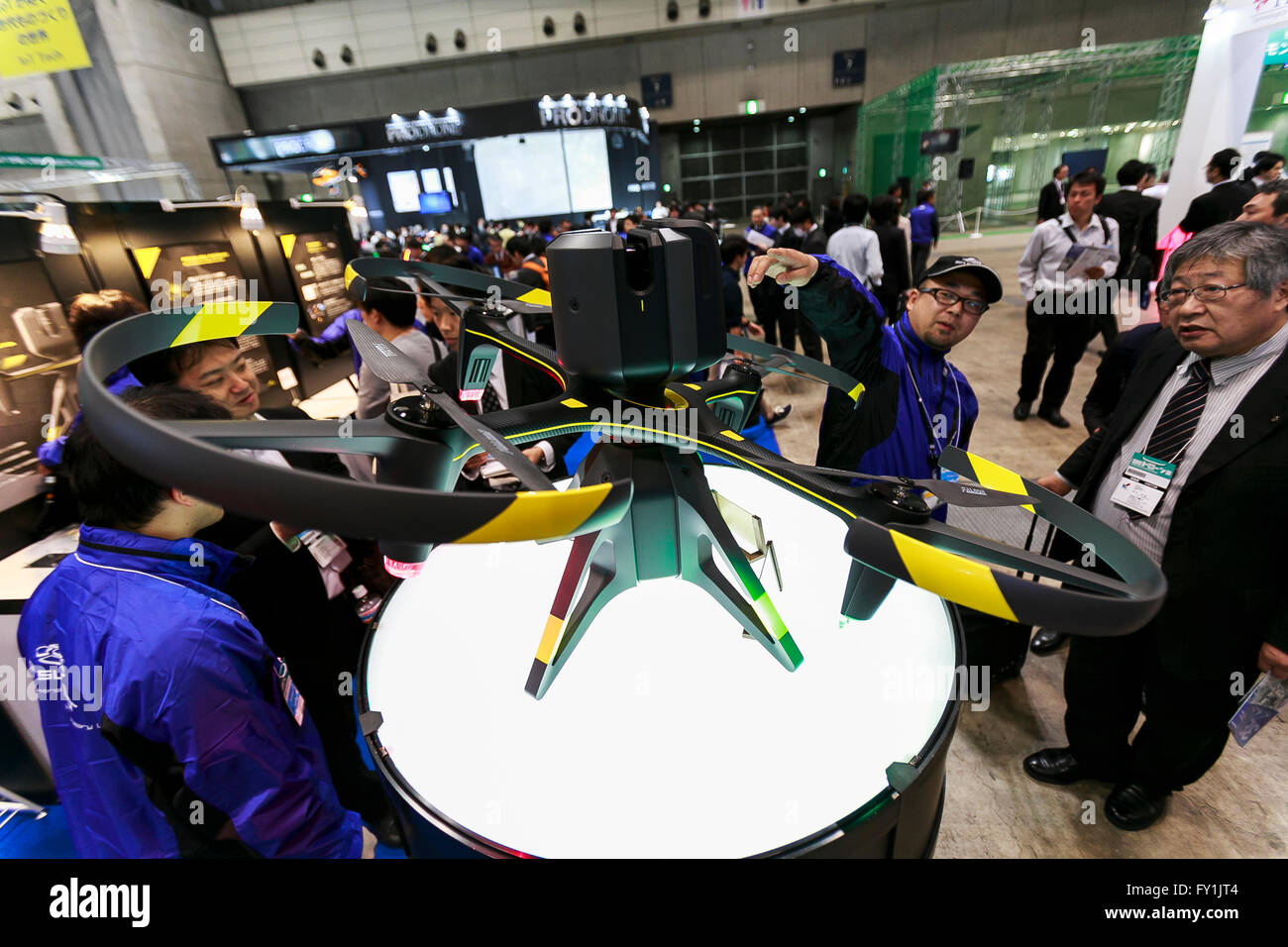 Visitors look at a drone on display at the Techno-Frontier 2016 ...