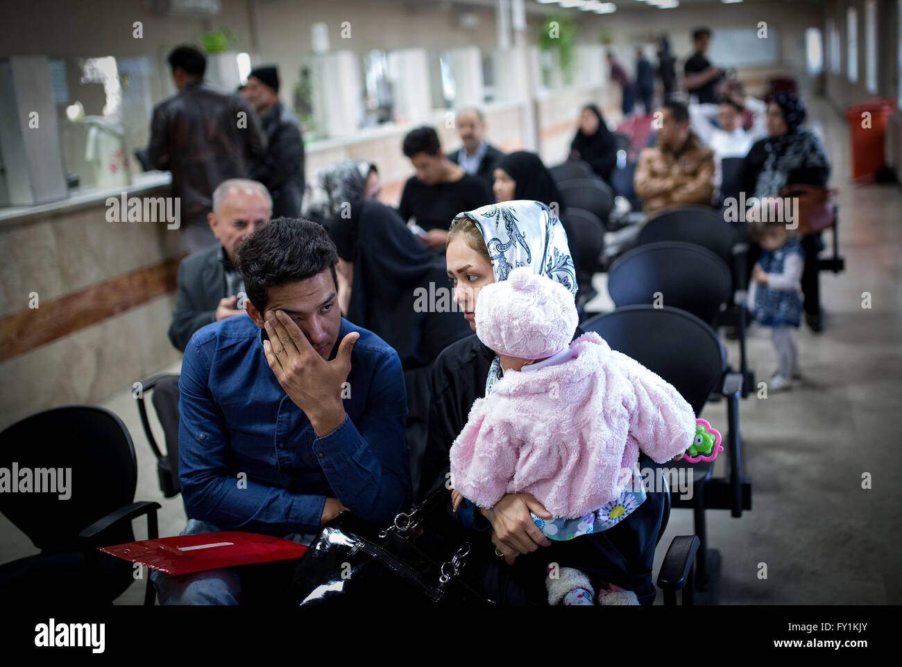 Tehran, Iran. 20th Apr, 2016. An Afghan refugee family wait to register ...