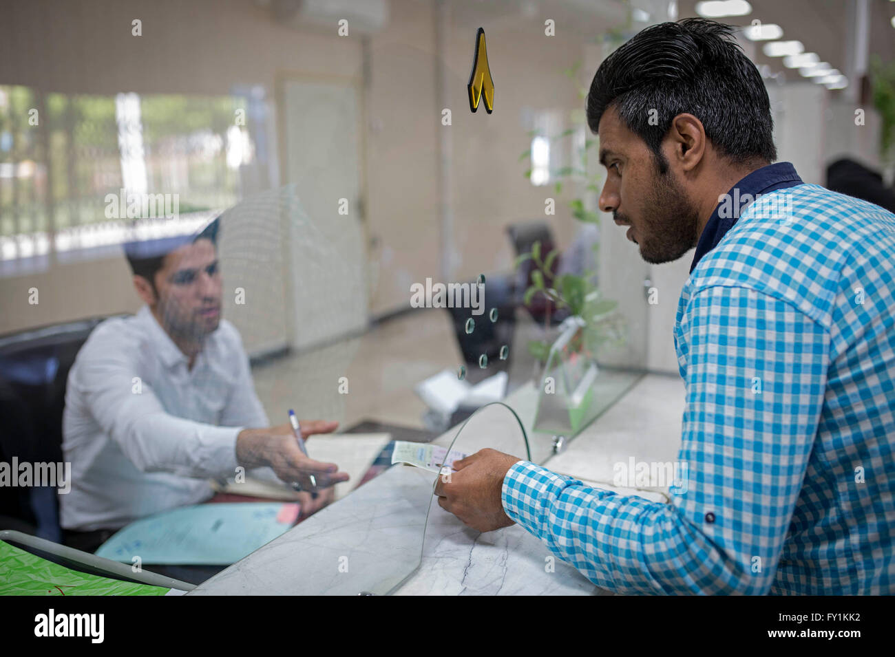 Tehran, Iran. 20th Apr, 2016. An Afghan refugee registers the name of ...