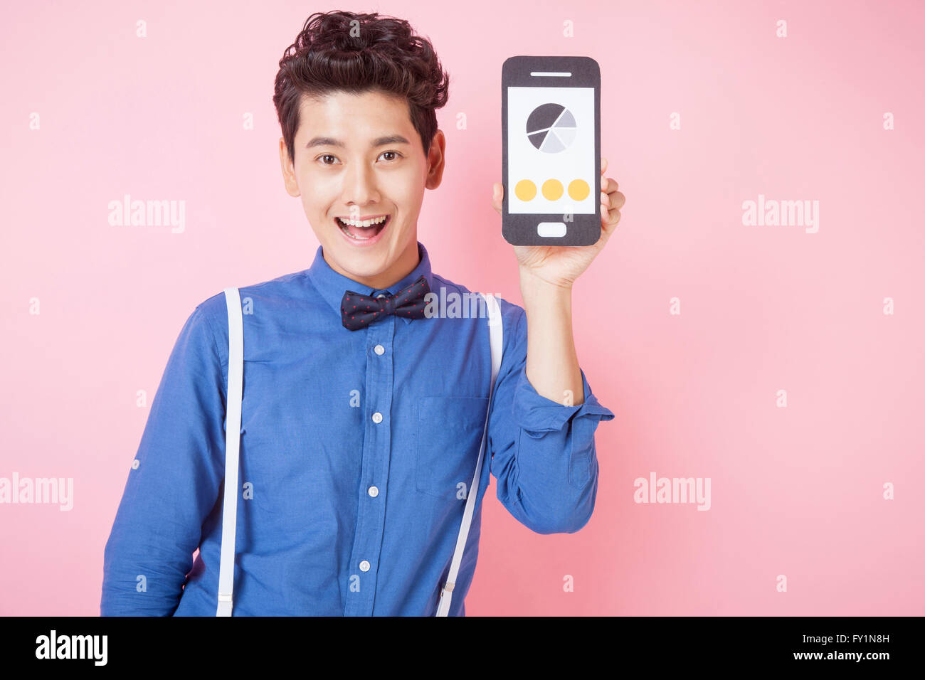 Portrait of young smiling man in retro style showing a smartphone ...