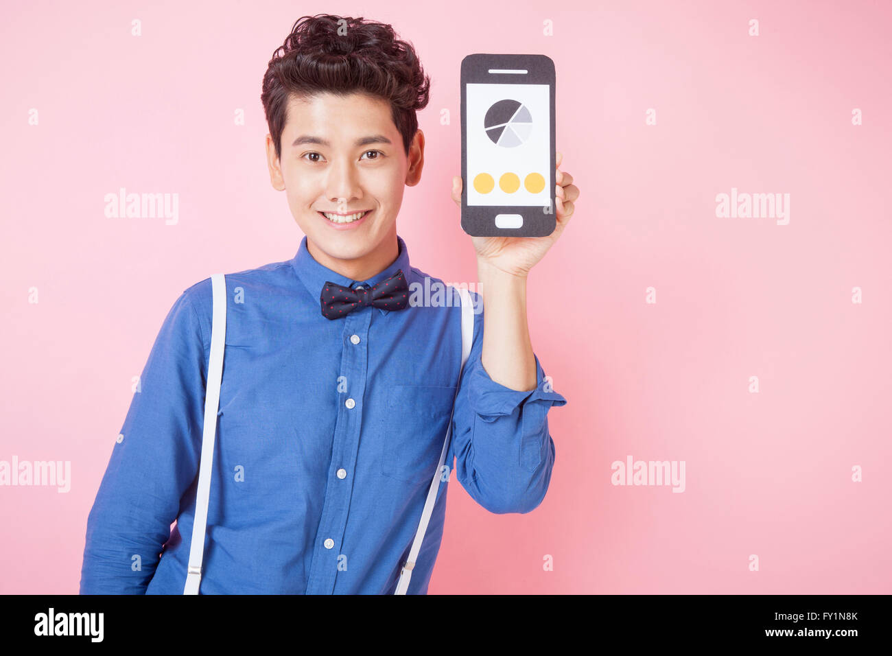 Portrait of young smiling man in retro style showing a smartphone ...