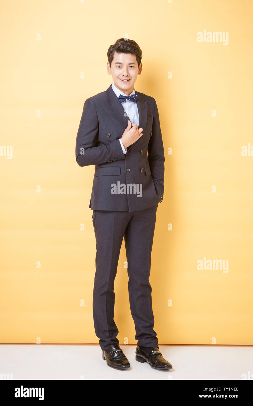 Young smiling man in retro style suit standing staring at front Stock ...