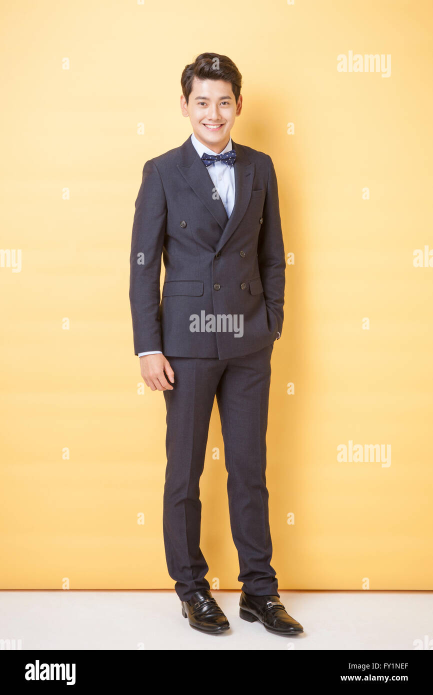 Young smiling man in retro style suit standing staring at front Stock ...