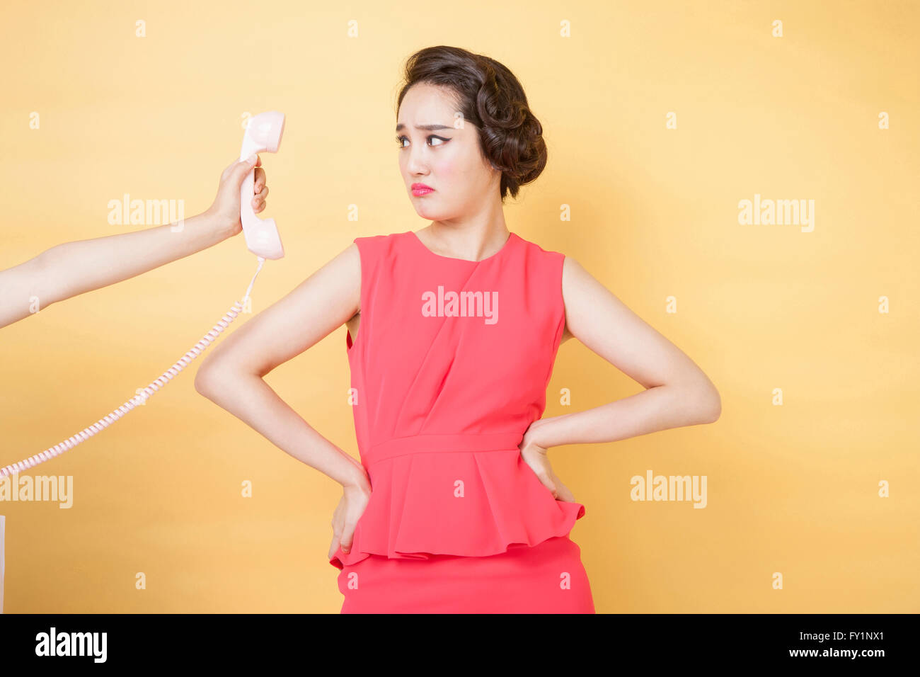 Young woman in retro style posing with a frown on her face looking at a ...