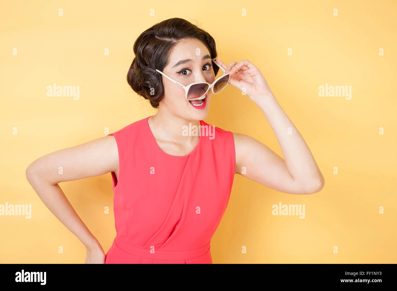 Portrait of young smiling woman in retro style wearing and touching her ...