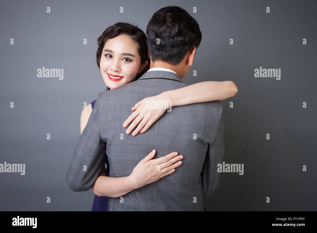 Portrait of young loving couple in retro styles hugging Stock Photo - Alamy