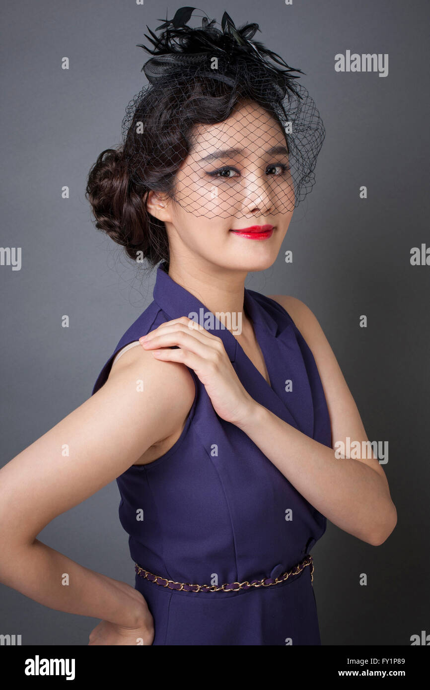 Side view portrait of young smiling woman in retro style staring at ...