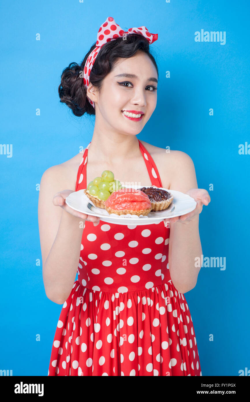 Young smiling woman posing with food staring at front Stock Photo - Alamy